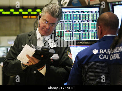 Trader Daniel Kryger works on the floor of the New York Stock Exchange ...