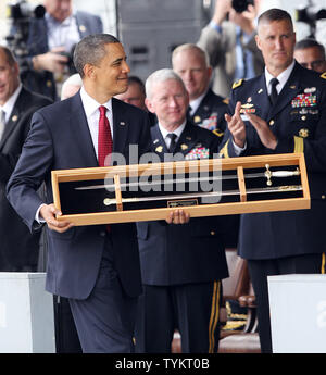 President Barack Obama receives a gift of a gold necklace called the ...