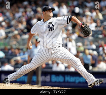 New York Yankees pitcher Joba Chamberlain delivers in a baseball game ...