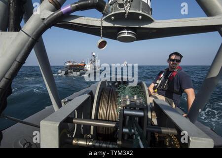 U.S. contractors with the Navy Mine Hunting Unit (MHU) test a common ...