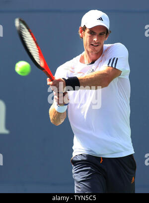 Alex Bogomolov Jr., of Russia, returns a shot to Britain's Andy Murray ...