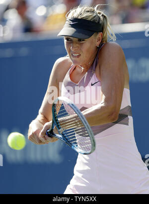 Maria Sharapova of Russia hits a backhand return to Virginie Razzano of ...