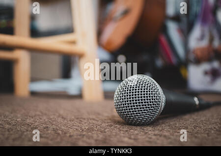 Singer lying on the floor with microphone Stock Photo - Alamy