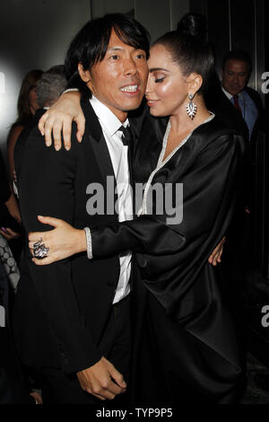 Lady Gaga and Stephen Gan arrive on the red carpet at Harper's Bazaar ...