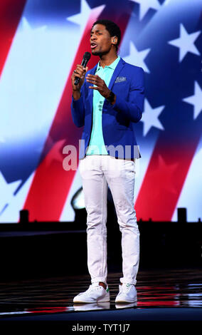 Jon Batiste sings the national anthem during the opening ceremony at ...