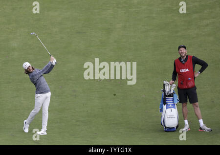 Tommy Fleetwood of England hits an approach shot on the 1st hole during ...