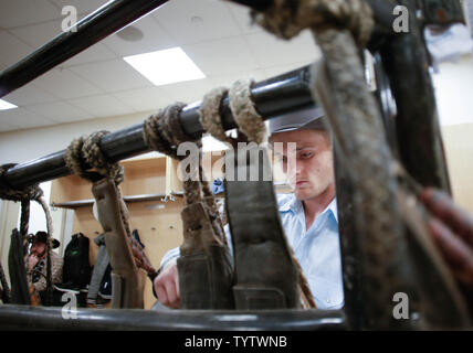 Competing bull riders get ready in the locker room at the Professional ...