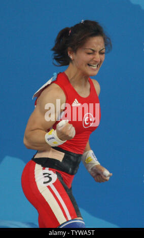 Turkish 48kg weightlifter Sibel Ozkan celebrates a good lift in women's ...
