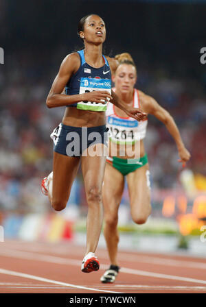 Muna Lee, right, crosses the finish line ahead of Torri Edwards and ...
