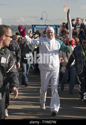 Torch bearer Mike Marcoux from Surrey runs the New Westminster Quay and ...