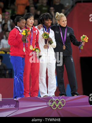 Winners of the judo Summer Olympic Games open category event stand on ...