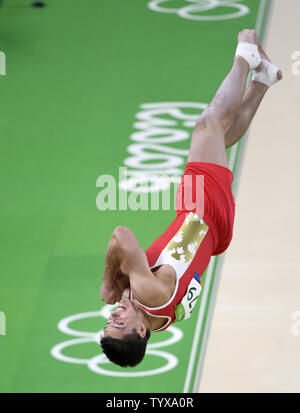 North Korea's Ri Se Gwang stands with his national flag after winning ...