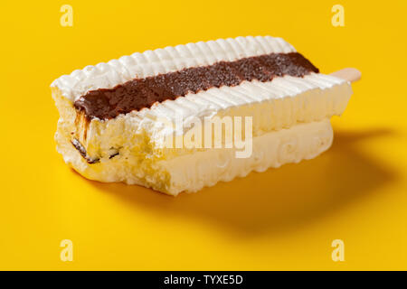side view yellow popsicle with a bite on a blue background Stock Photo ...