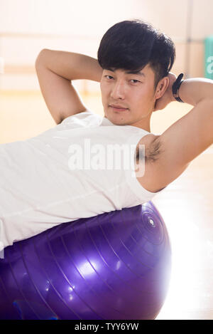 young handsome man works out in modern gym Stock Photo - Alamy