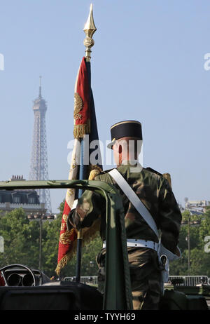 A soldier awaits the start of the annual Bastille Day parade along the ...