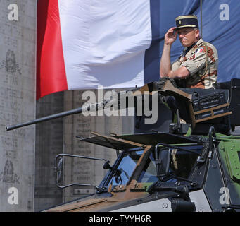 A French soldier awaits the start of the annual Bastille Day military ...