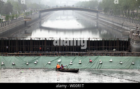 Chinese workers clean a heavily-polluted canal running through central ...