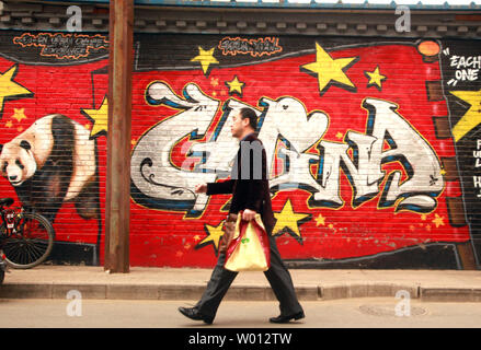 Chinese graffiti artists adorn a building with a nationalistic, or ...