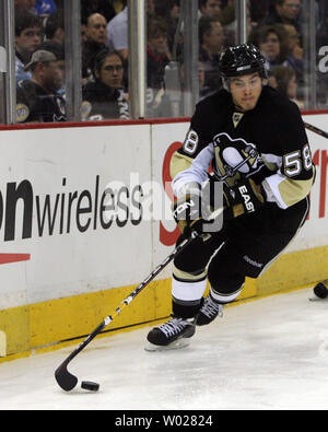 Pittsburgh Penguins' Kris Letang (58) returns to the bench with Sidney ...