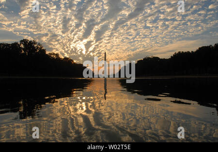 The sun rises near the Washington Monument early, Wednesday, July 1 ...