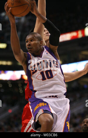Phoenix Suns' Leandro Barbosa, of Brazil, holds kisses his trophy after ...