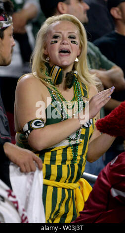 A Green Bay Packers fan cheers before an NFL football game against the ...