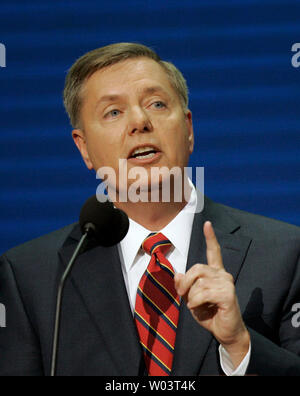 Sen. Lindsey Graham, R-S.C., center, walks to speak to reporters ...