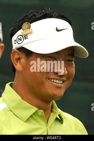 K.J. Choi, of South Korea, watches his shot from the eighth fairway during Pro-Am competition of ...