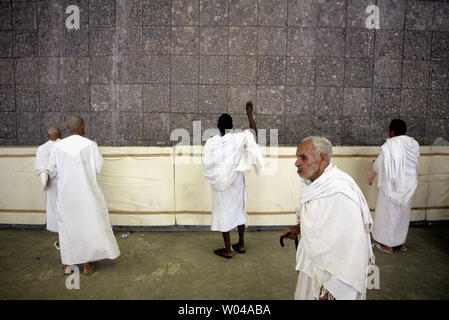 Pilgrims stoning one of the three pillars that symbolices the devil ...