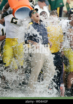 Michigan players douse head coach Lloyd Carr, center, with ice water ...