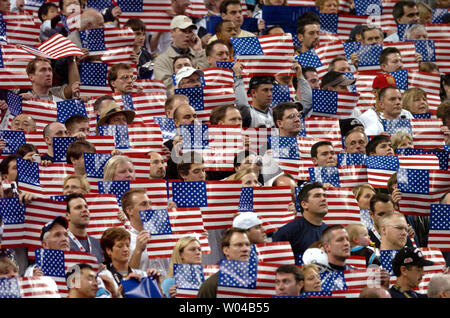 Fans stand for the playing of the national anthem before a spring ...