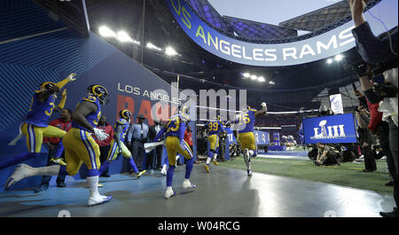 The New England Patriots run onto the field during an NFL football game ...