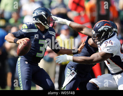 Seattle Seahawks defensive end DeMarcus Lawrence, center, speaks to the ...