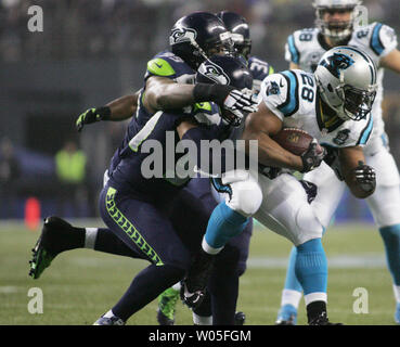 Seattle Seahawks defensive tackle Tony McDaniel (99) flexes his muscles ...
