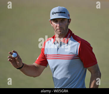 Dustin Johnson walks off the green on the 17th hole during the first ...