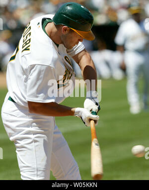 Oakland Athletics' Bobby Crosby hits a single to drive in Damian Miller ...