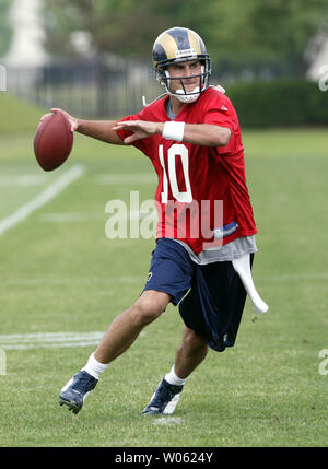 St. Louis Rams' quarterback Mark Bulger fumbles after being hit by ...