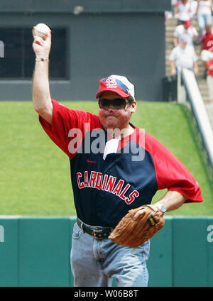 Belleville, Illinois Police Sgt. Jon Brough is helped to the field by ...
