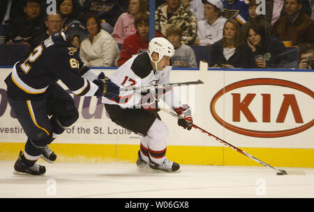 New Jersey Devils' Mike Rupp, left, ducks as Los Angeles Kings' Raitis ...