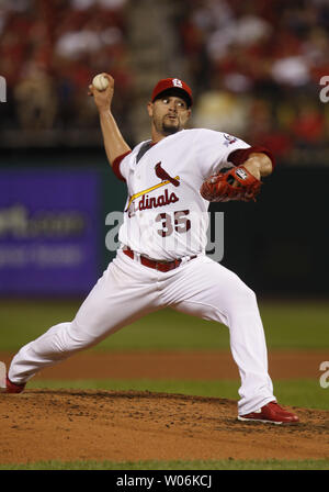 St. Louis Cardinals' Joel Pineiro follows through on a two-run double ...