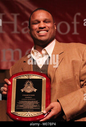 St. Louis Rams' D'Marco Farr holds onto his crutches during a news ...