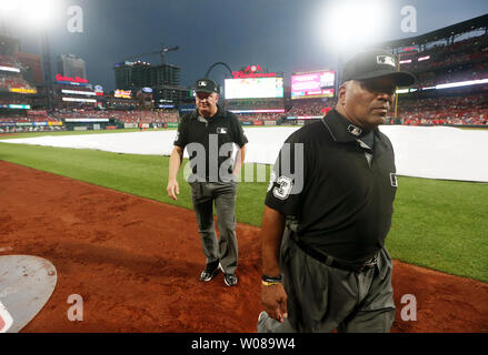 Busch Stadium grounds crew chief BIll Findlay shows umpires (R to L ...