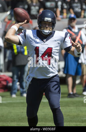 Houston Texans' Ryan Fitzpatrick (14) grabs is children from the stands ...