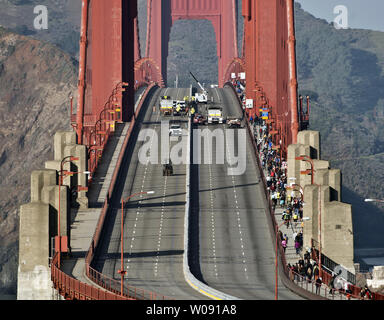 Workers install a movable median barrier on the Golden Gate Bridge in ...
