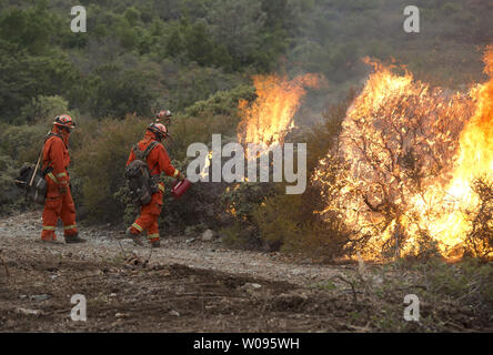 Firefightersl set a backfire along a ridge in Colusa County, California ...