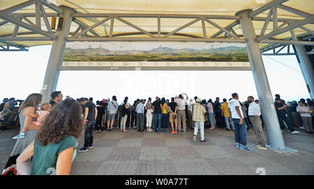 A tourist use binoculars to see North Korea at the Dorasan Observatory ...