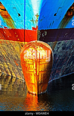 Red bulbous bow of container vessel in detail view, which is half ...