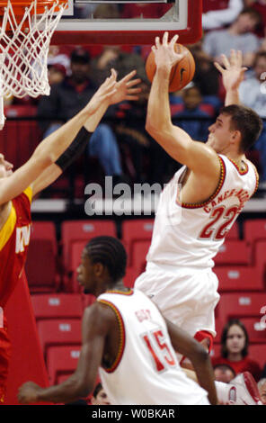 Nik Caner-Medley of the Maryland Terrapins goes to the basket and is ...