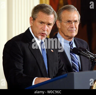 Defense Secretary Donald Rumsfeld, is flanked by daughters Marcy, left ...