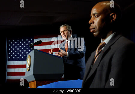 President George W Bush is guarded by Secret Service Agents during his ...